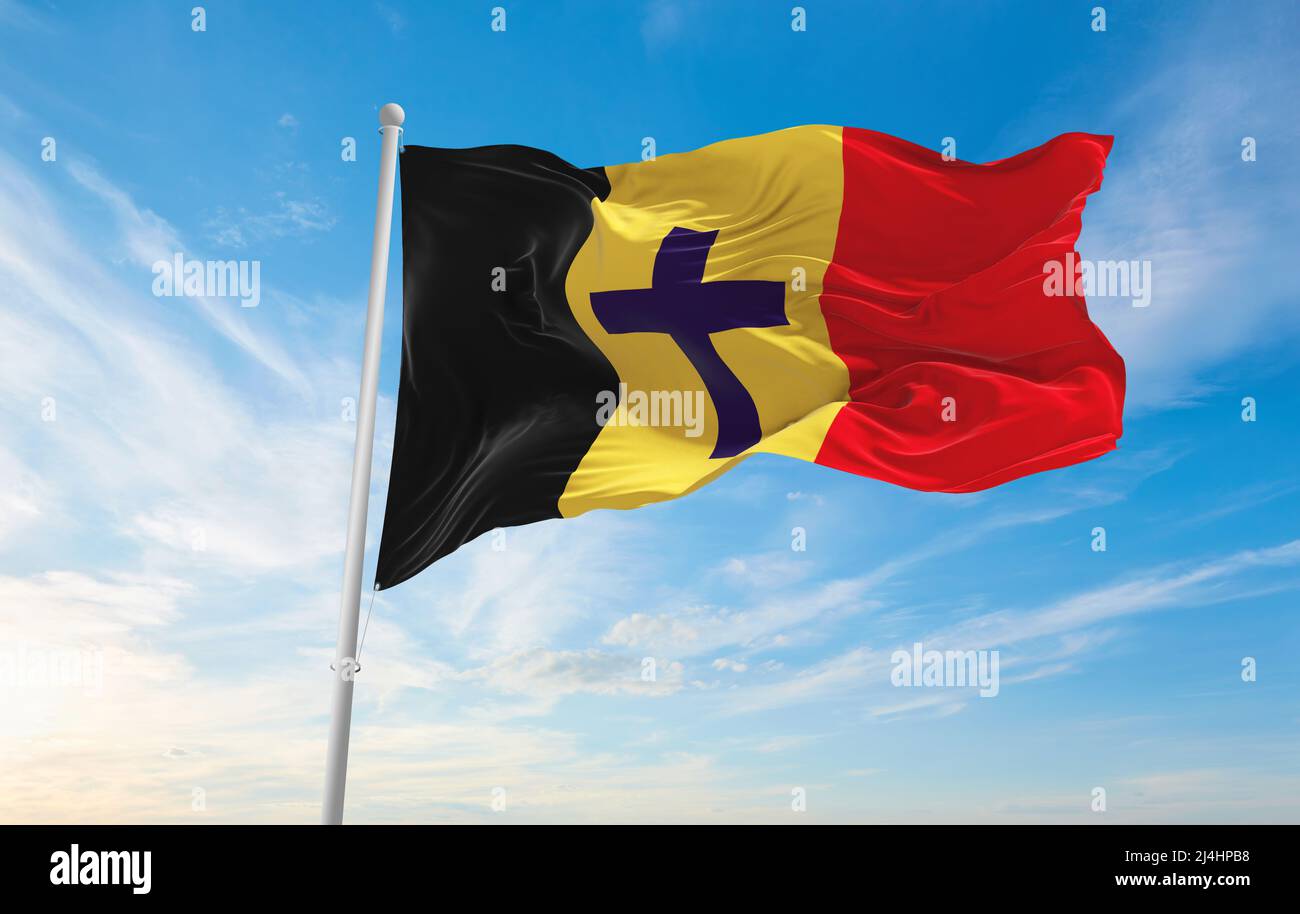 official flag of Armed Forces Bishop, Belgium at cloudy sky background ...