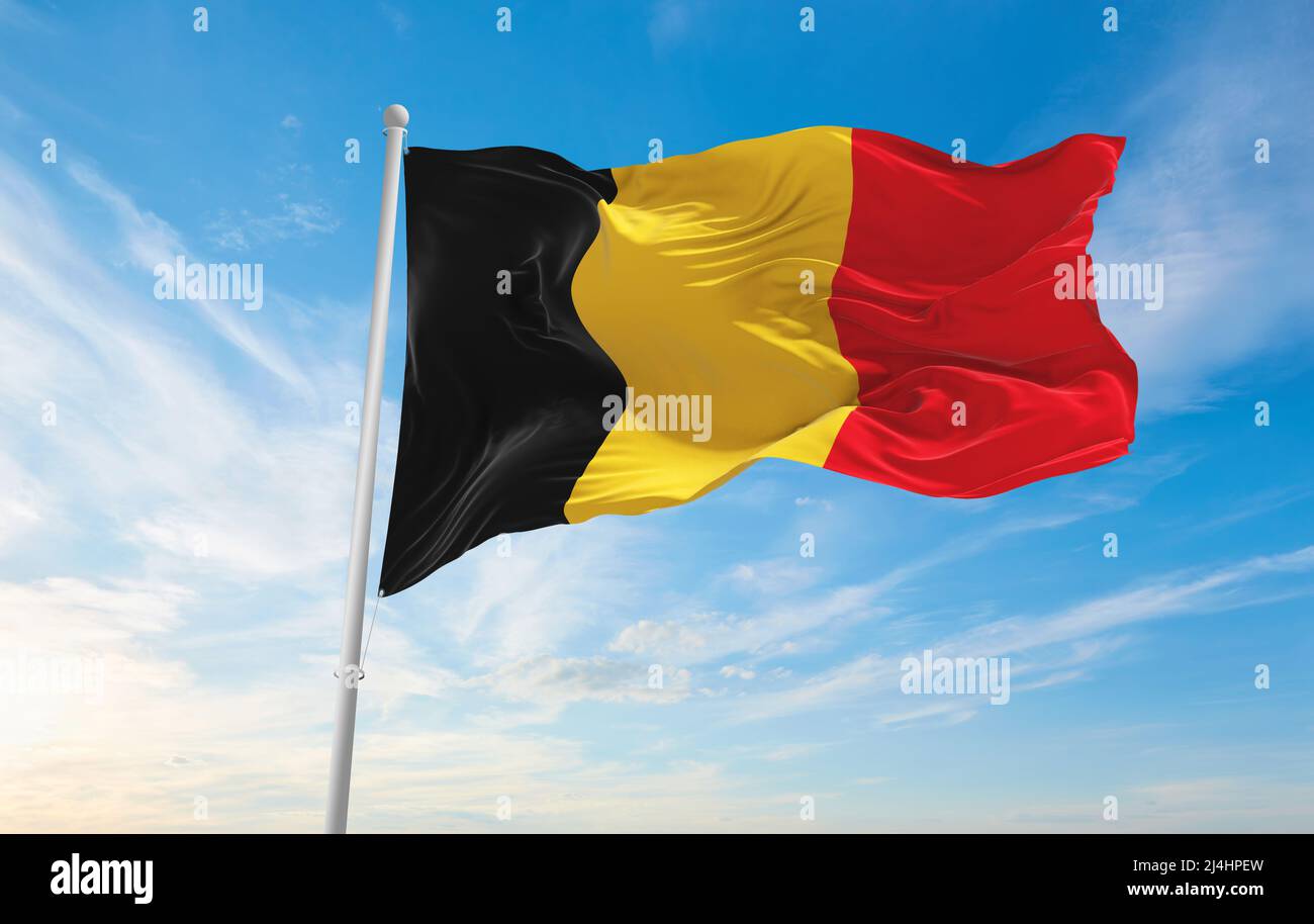 official flag of Belgium civil, Belgium at cloudy sky background on ...