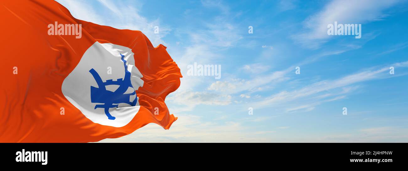 official flag of Verdinaso, Belgium at cloudy sky background on sunset ...