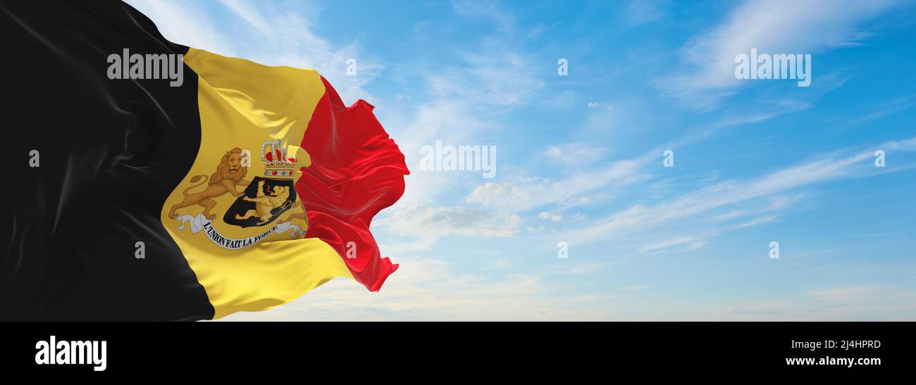 official flag of Royal ensign 1858, Belgium at cloudy sky background on ...