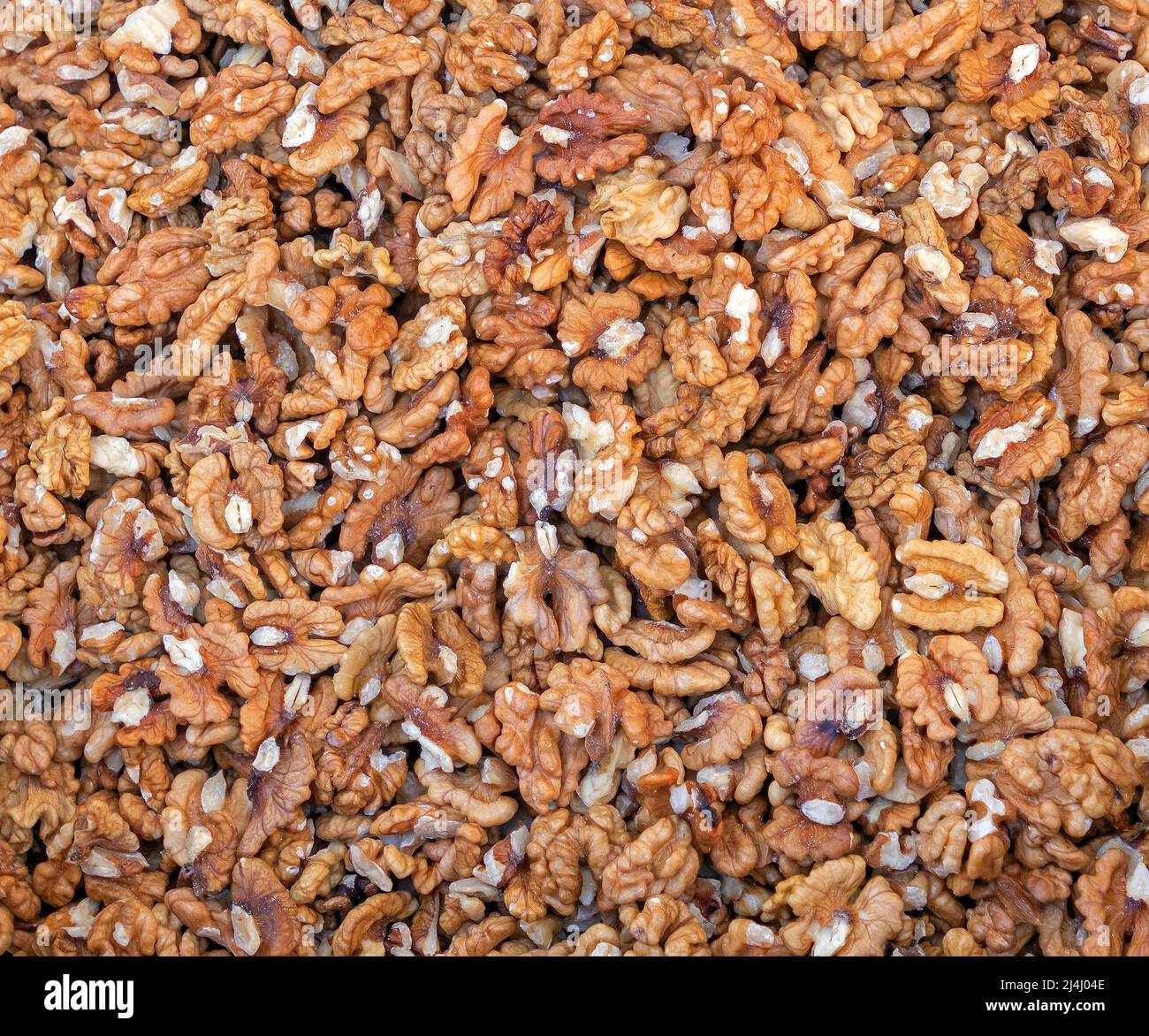 Large pile of cleaned open walnut nuts background Stock Photo - Alamy