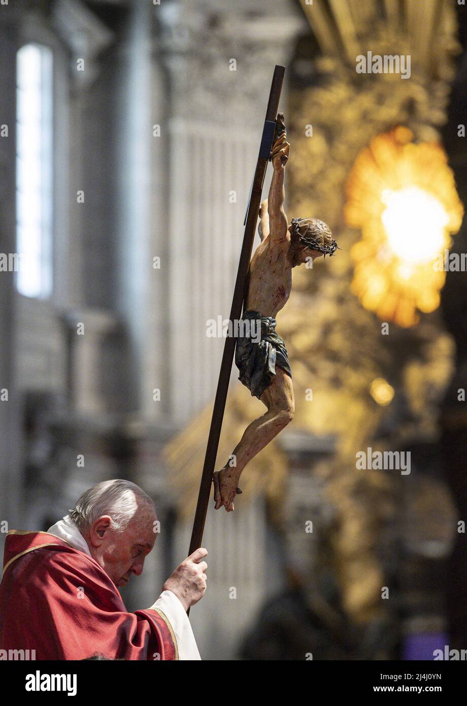 Pope Francis kisses the cross during the celebration of the Passion of ...