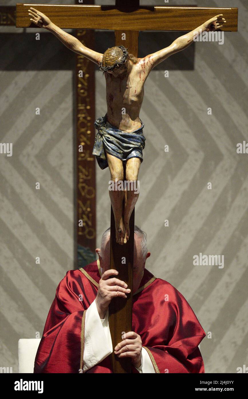 Pope Francis carries the cross during the celebration of the Passion of ...