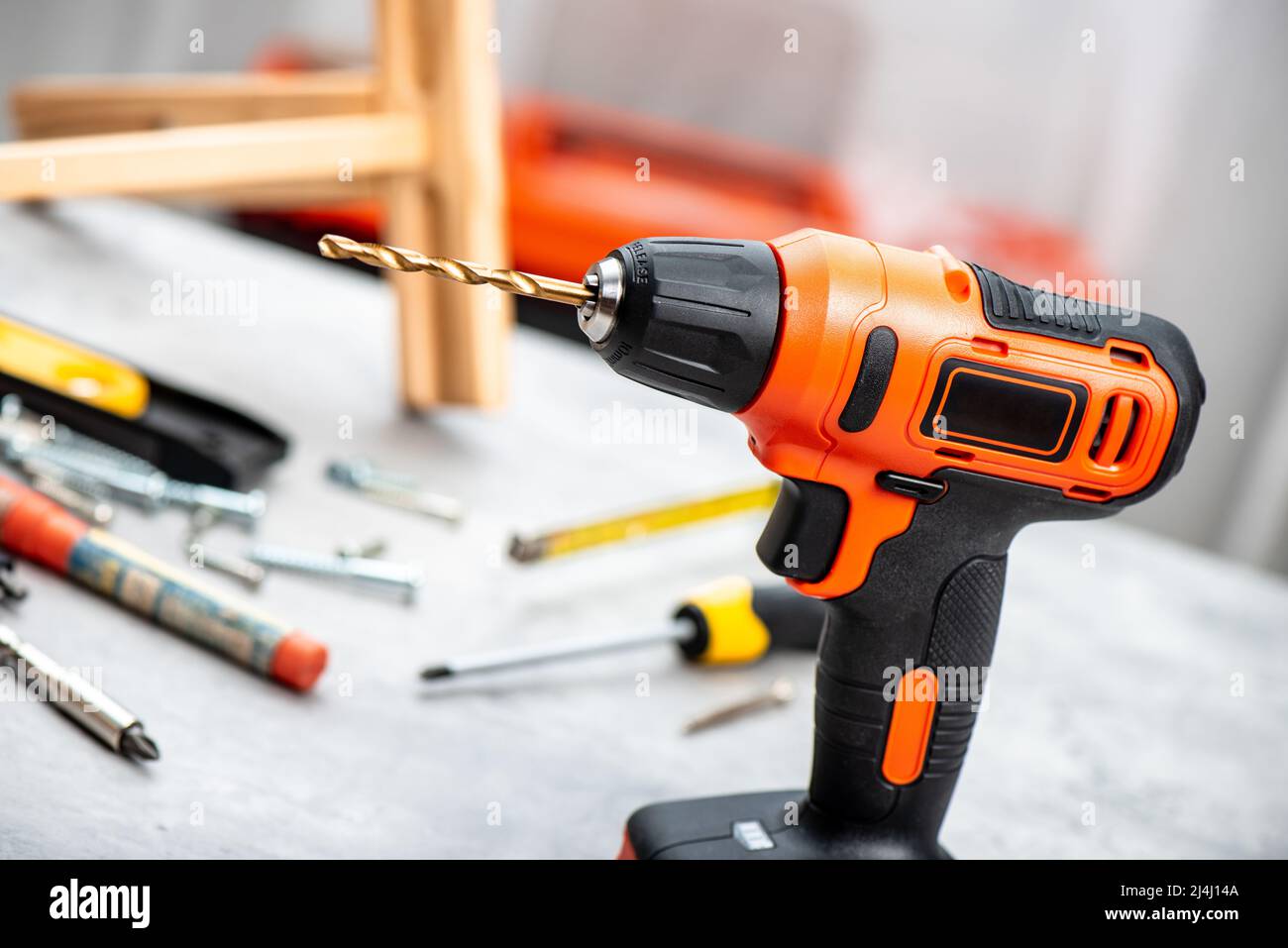 Black-orange cordless screwdriver drill. Power tool for construction ...