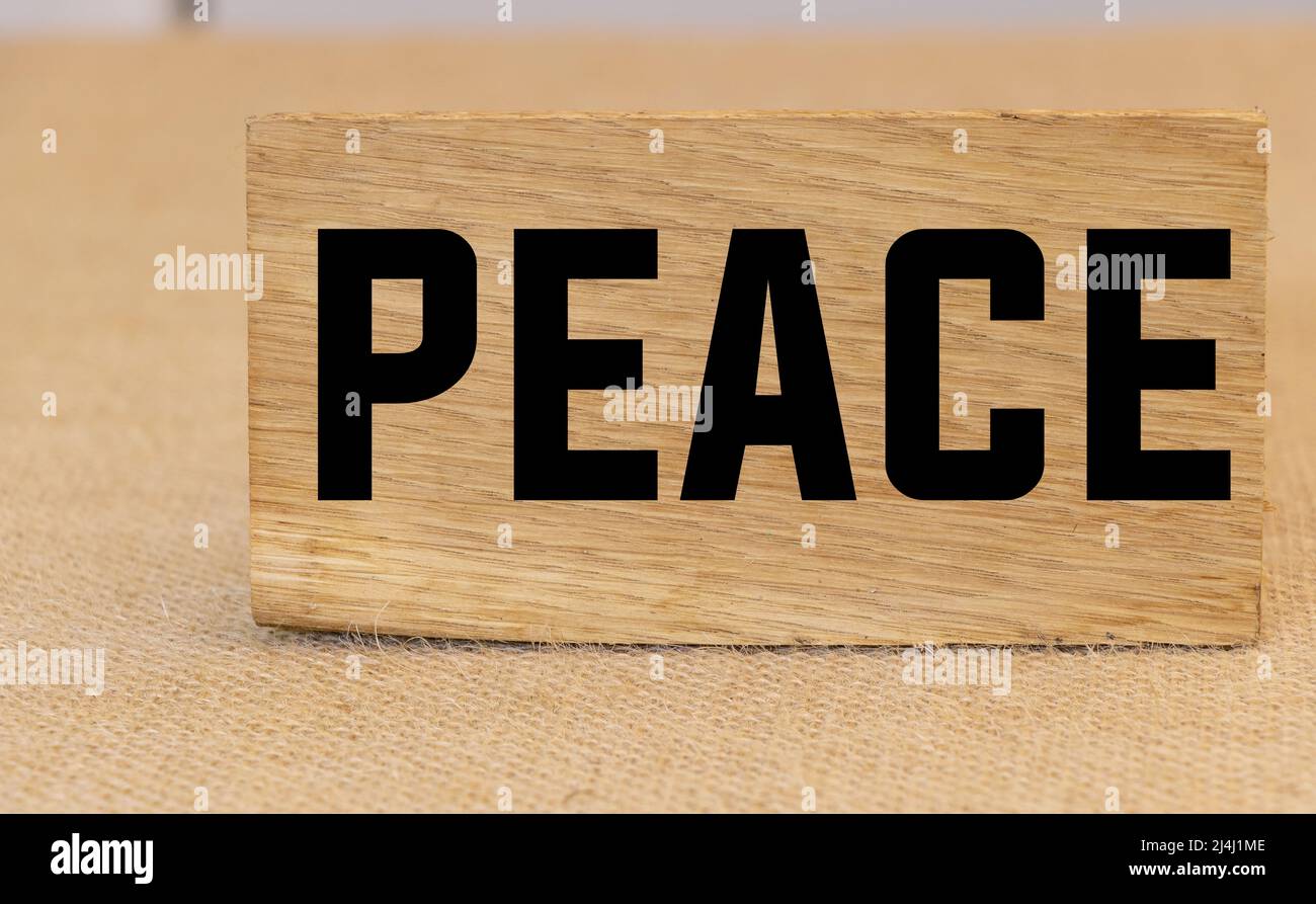 Peace text written on a piece of wood concept Stock Photo - Alamy