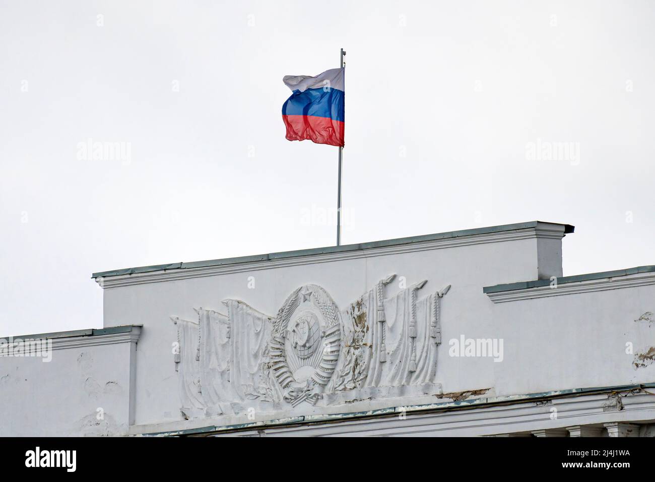 russian flag waving on top of building in moscow city russia against ...