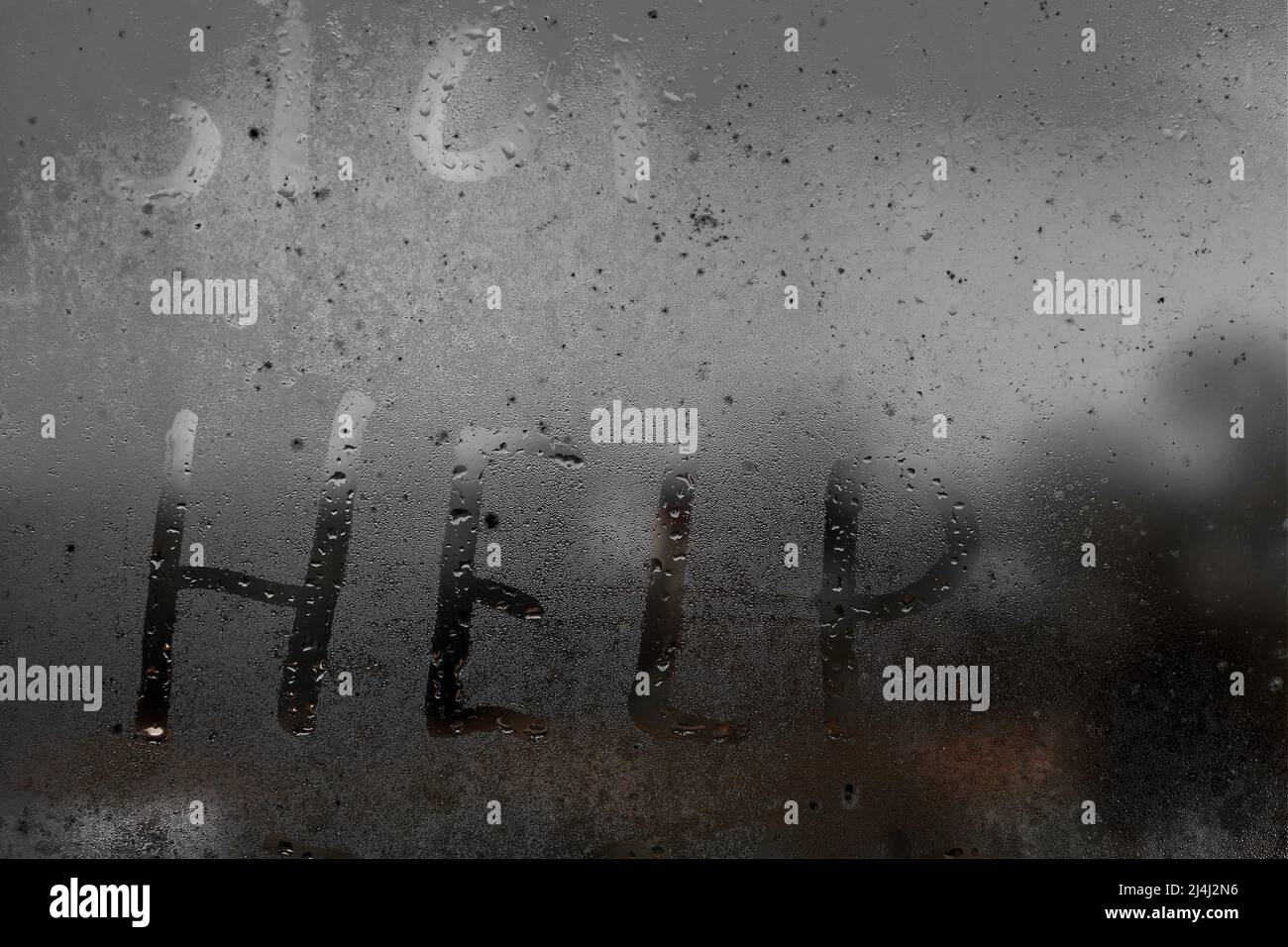 words help handwritten on night wet window glass with green and blue ...