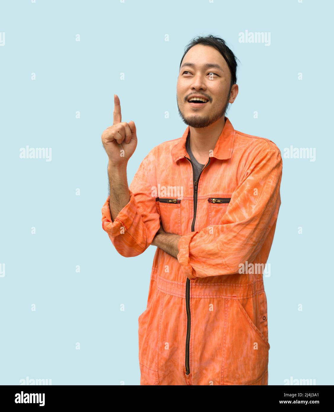 The chief mechanic in an orange uniform pointing one finger in upward ...