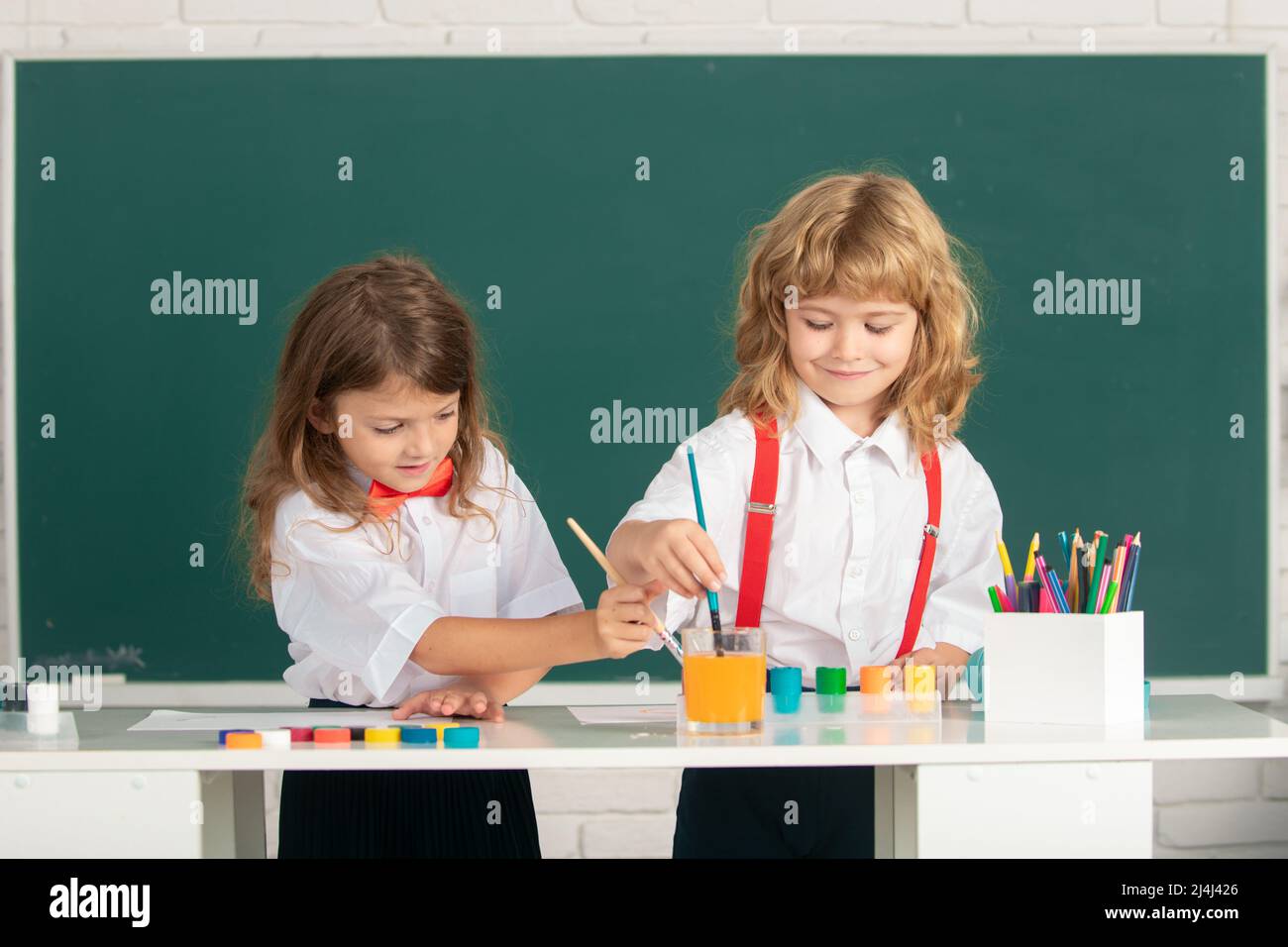 Portrait school kids doing art homework. Children drawing on school ...
