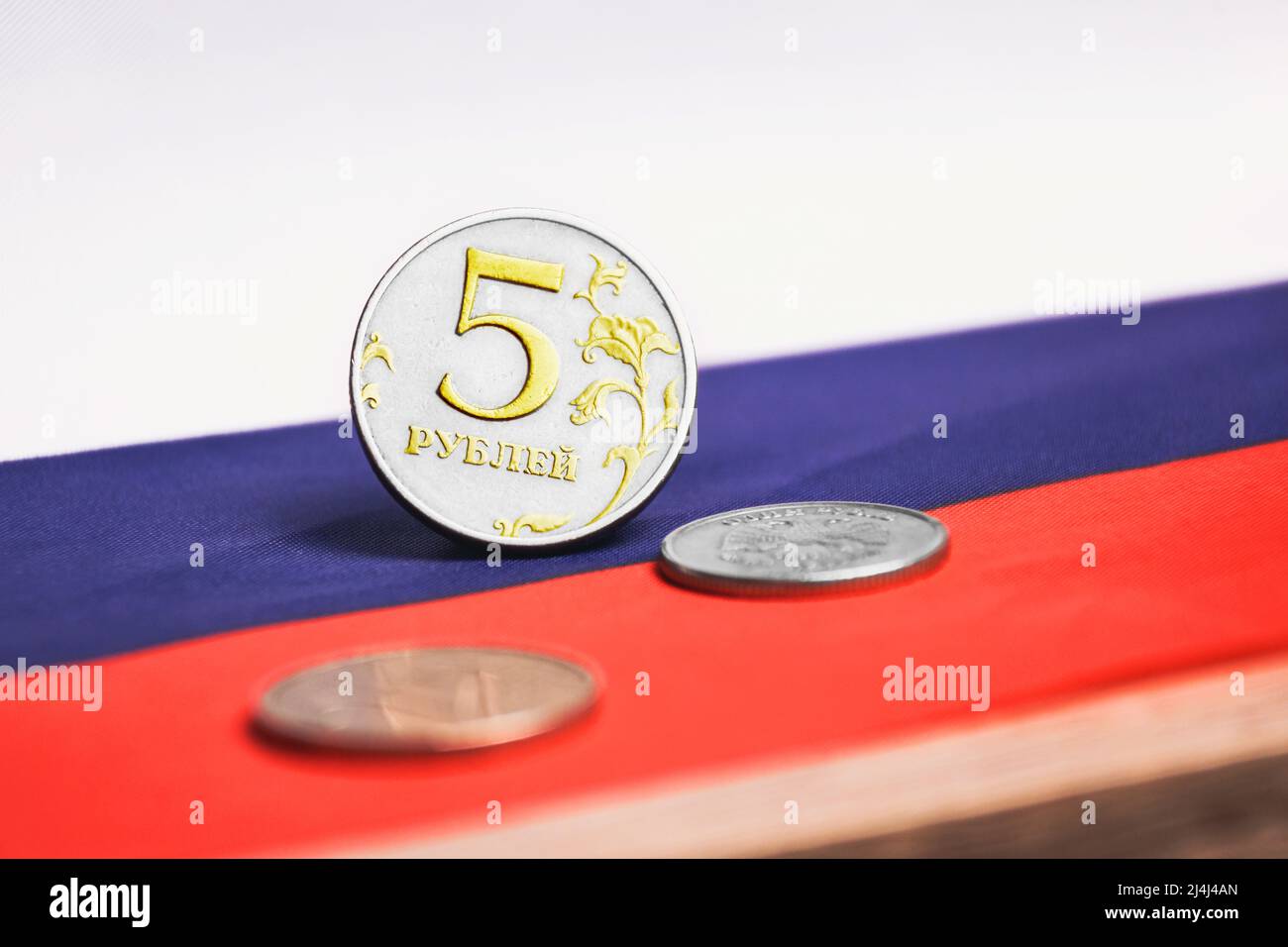 Five ruble coin on the flag of Russia Stock Photo - Alamy