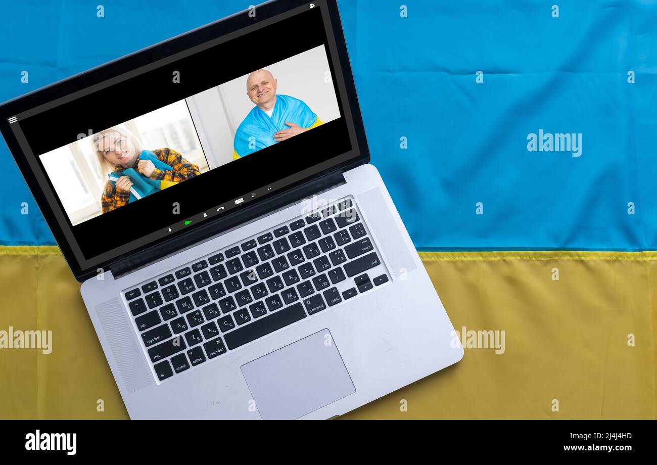 laptop near the ukraine flag. online conference Stock Photo - Alamy