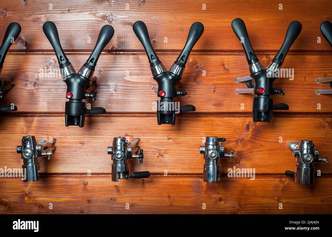 Beer taps for draught drinks are built into wooden boards Stock Photo ...