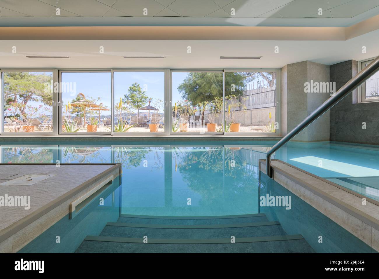 Steps and railing entrance in a swimming pool of a hotel with beach ...