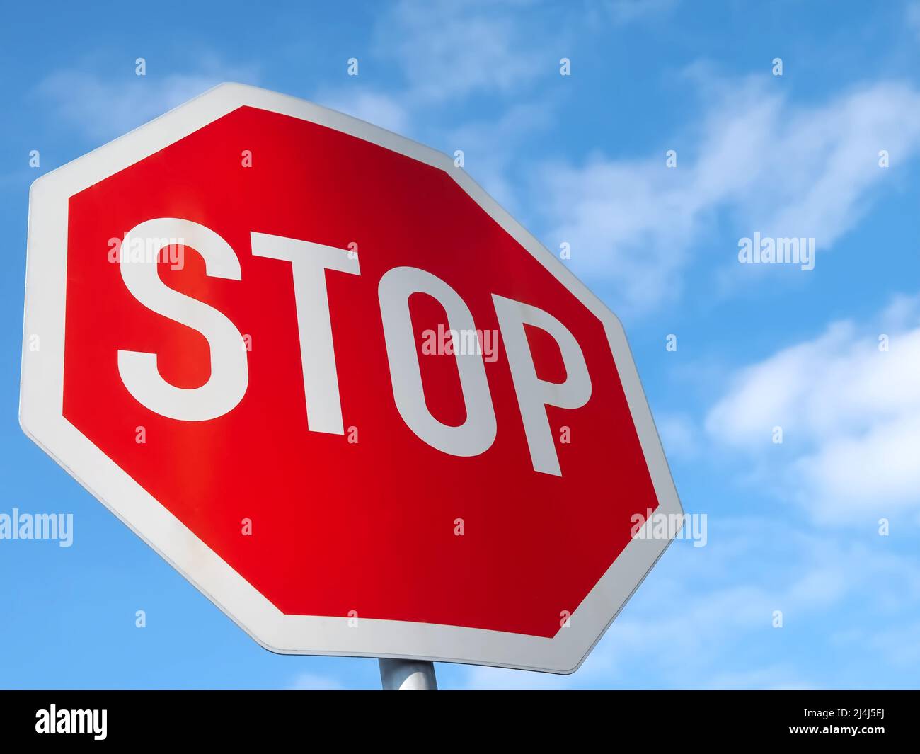 Stop sign for vehicles with blue sky and clouds Stock Photo - Alamy