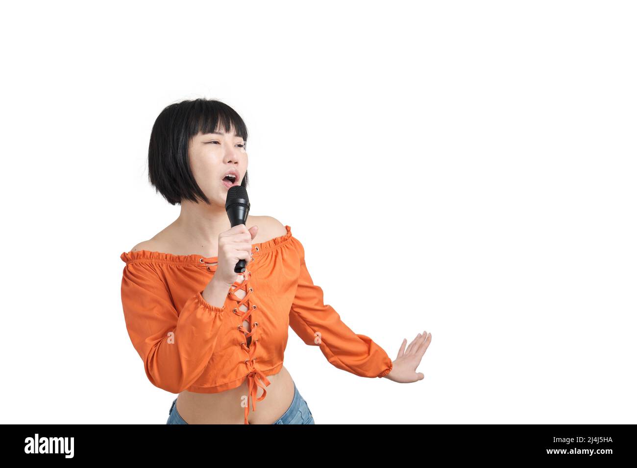 Young asian woman singing and dancing with microphone, isolated Stock ...