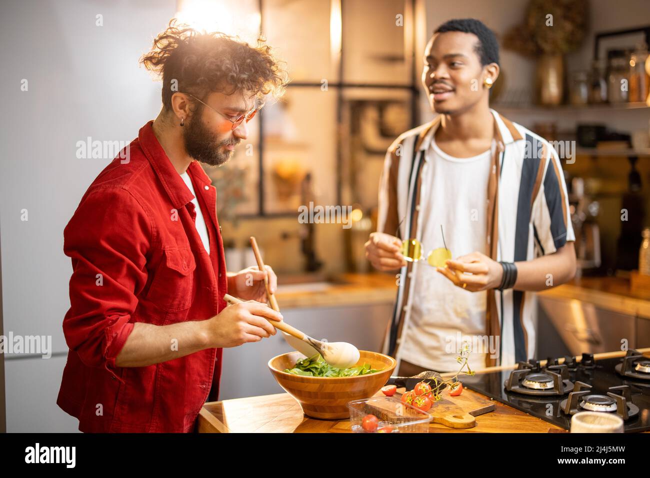 Two guys cooking healthy together at home Stock Photo - Alamy