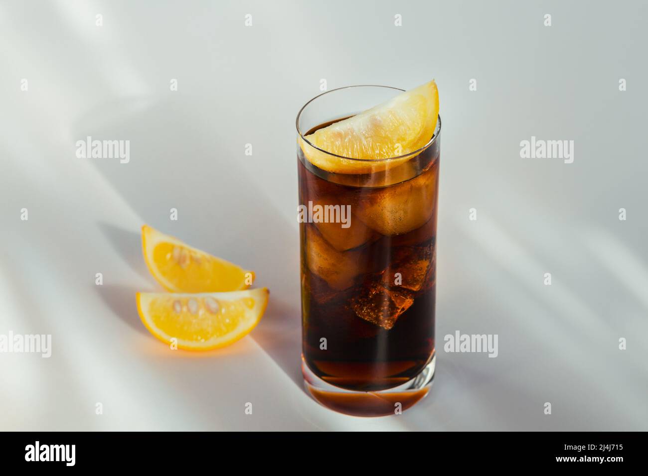 Glass of cola with ice and lemon Stock Photo - Alamy