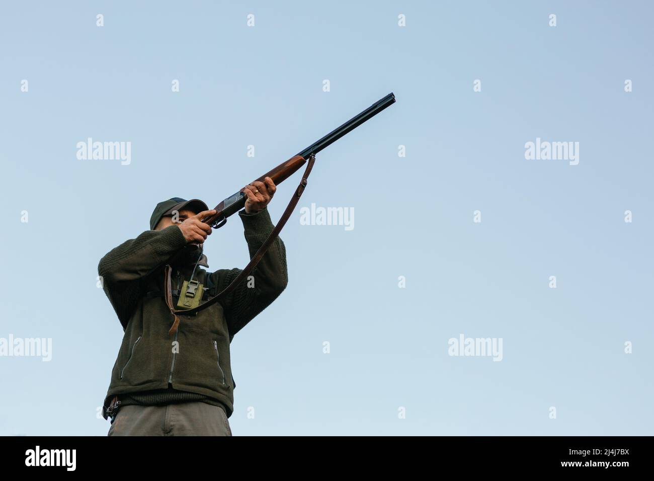 Male hunter with rifle aiming on bird in nature Stock Photo - Alamy