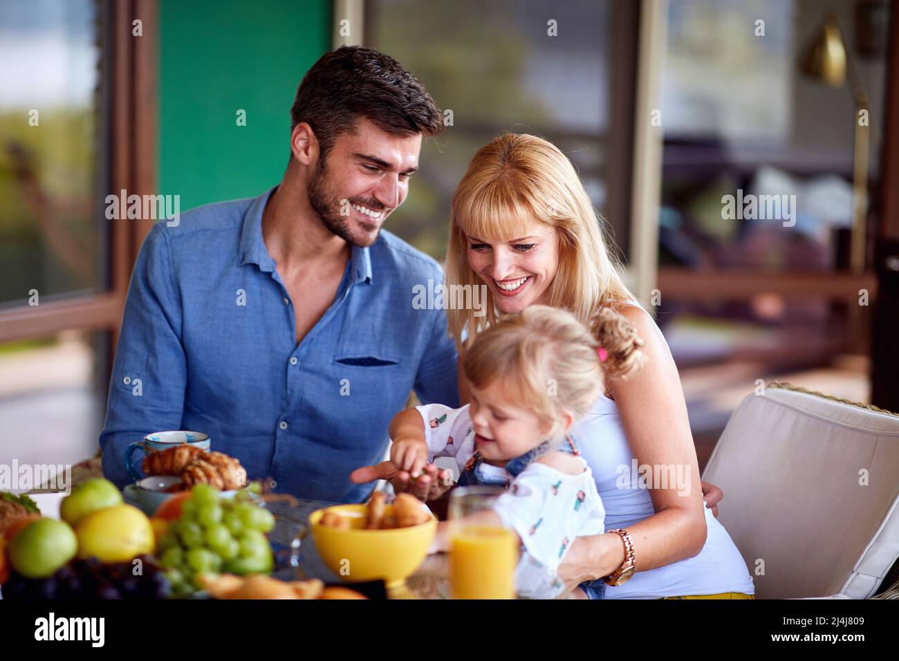 Family with daughter having breakfast outdoor Stock Photo - Alamy