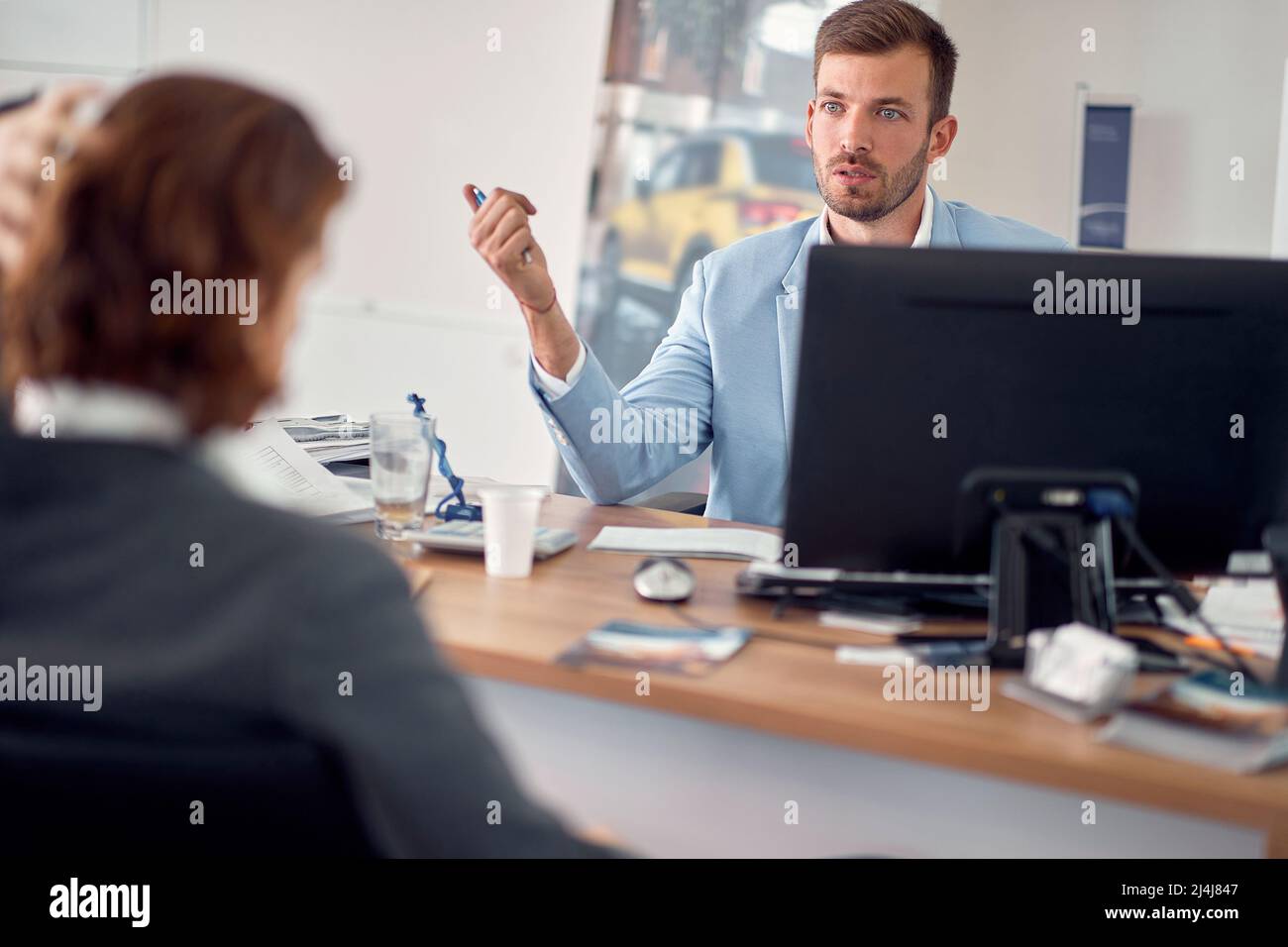 Woman talking to male customer desk hi-res stock photography and images ...
