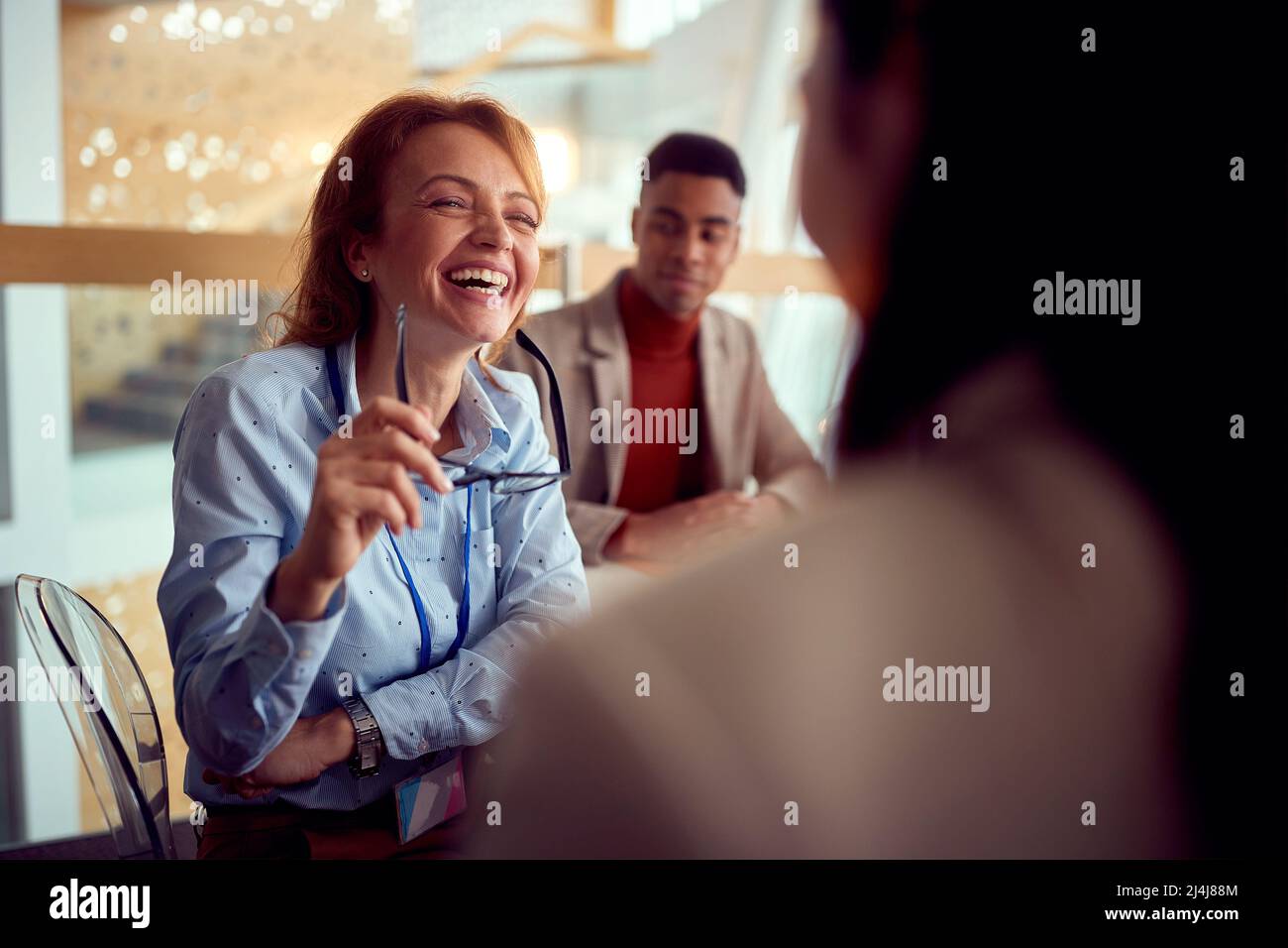 Group of work colleagues socializing on a break in the office Stock ...