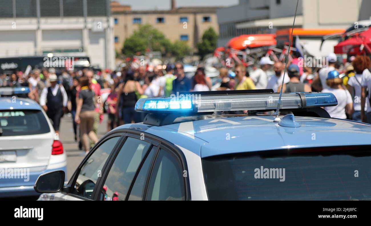 police car with blue flashing lights above during escort and protest ...