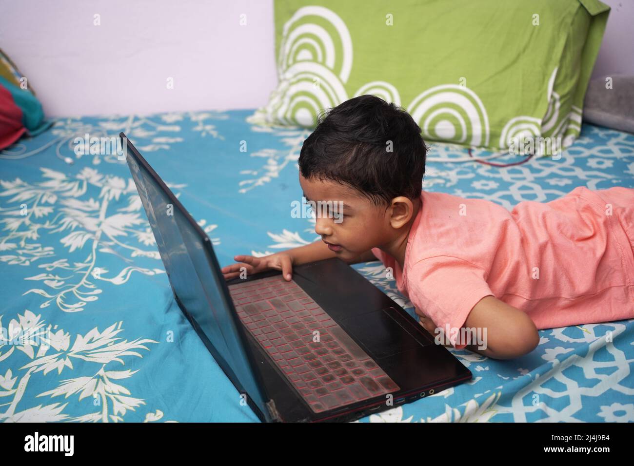 a toddler baby boy engaged in watching and exploring laptop.Screen time ...