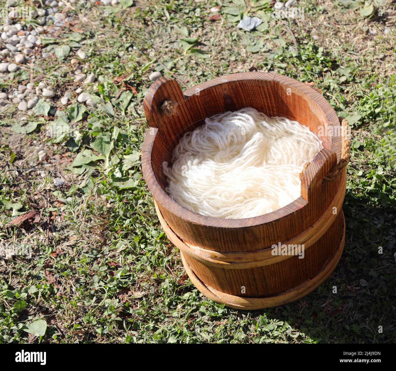 antique wooden bucket for coloring wool with the ancient medieval ...