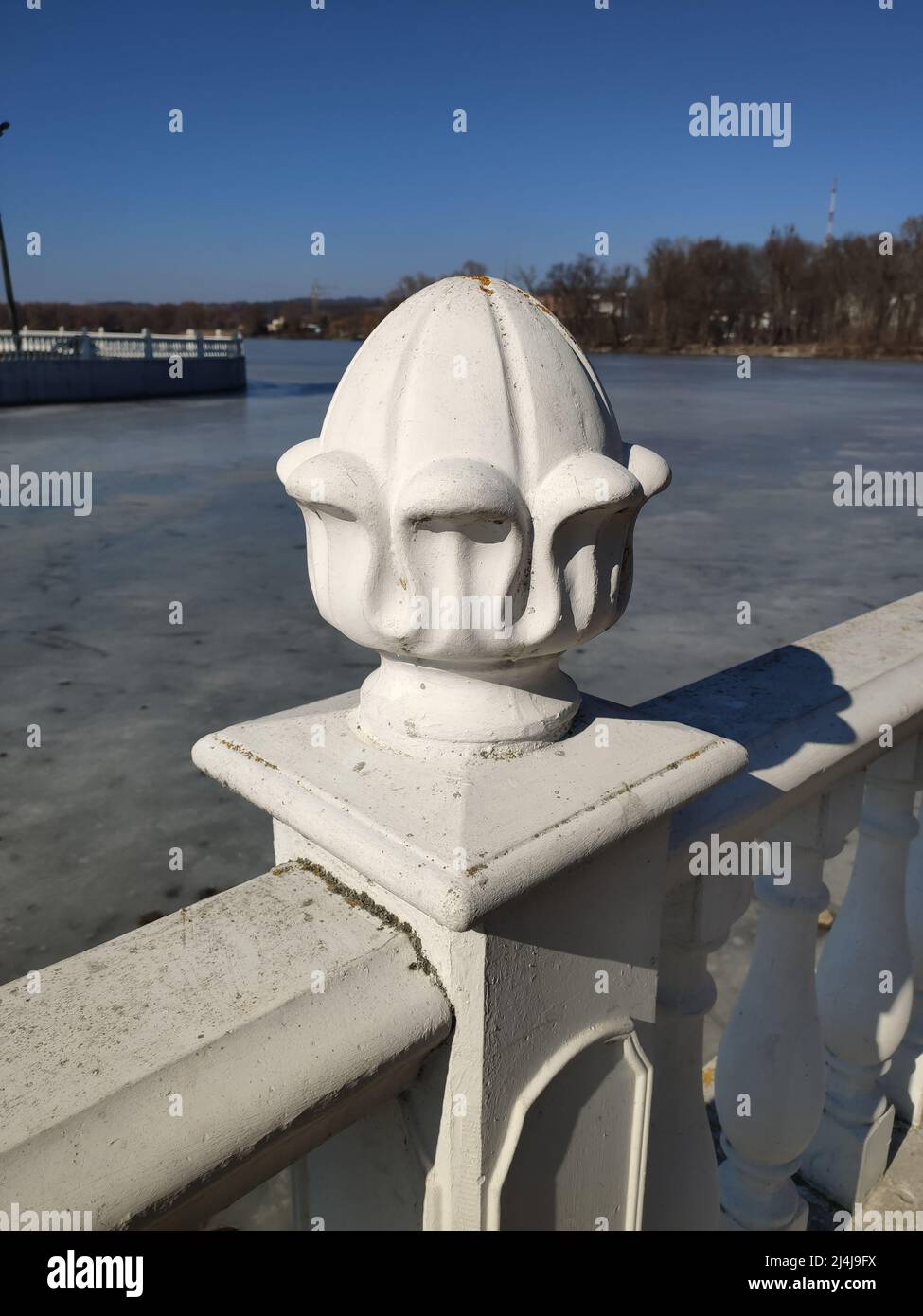 a beautiful embankment with columns fence the river in the park Stock ...