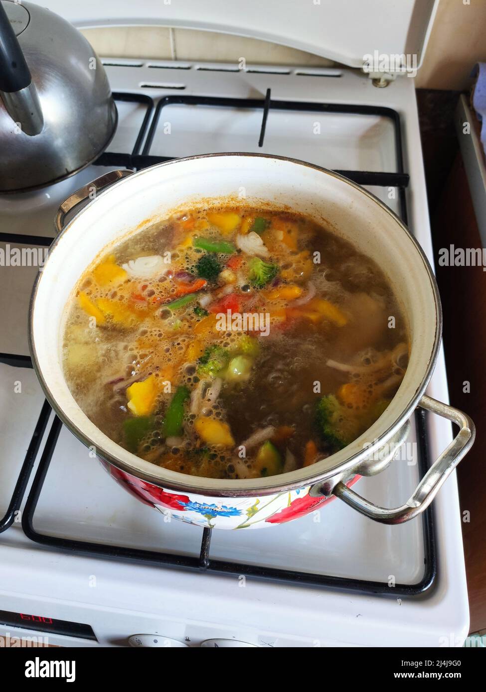 Pot of chicken soup on stove hi-res stock photography and images - Alamy