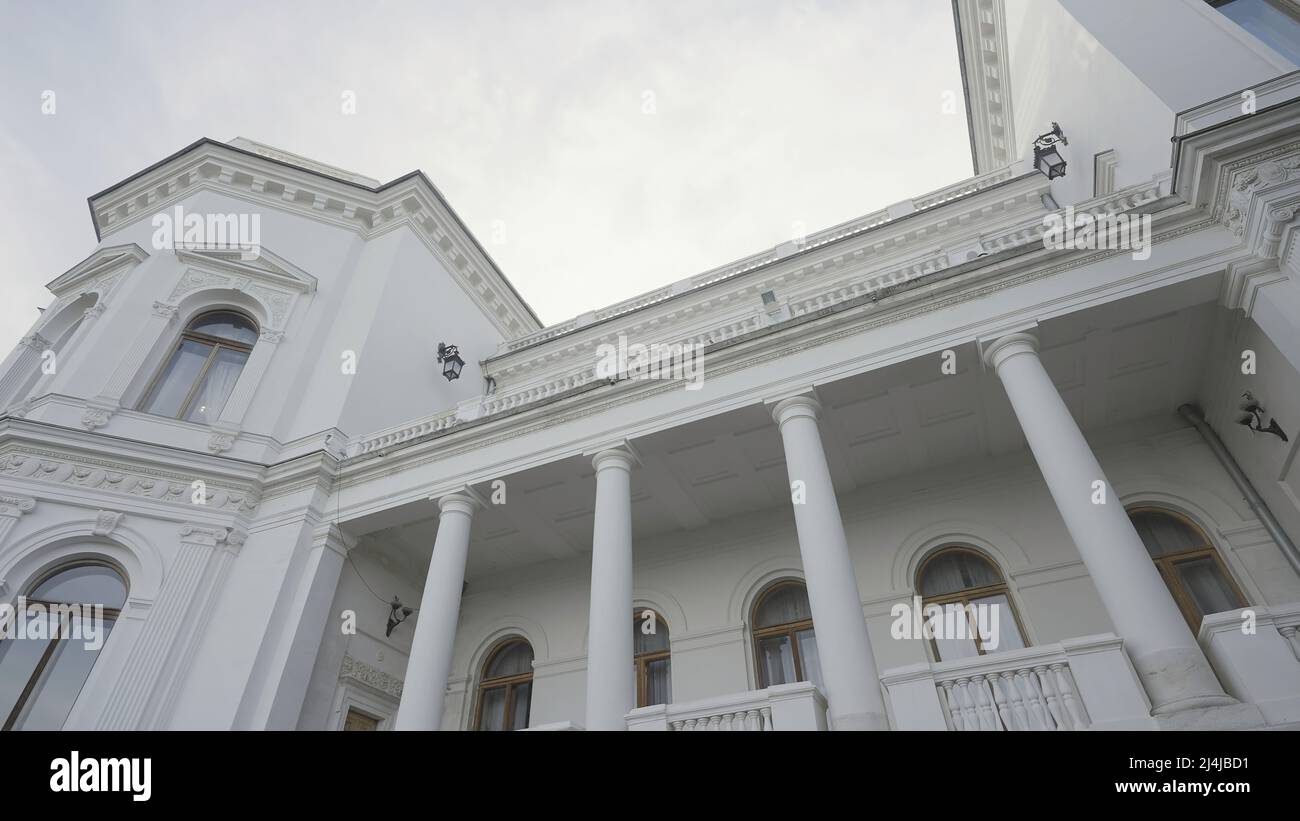 Beautiful old building with white facade. Action. Beautiful white ...