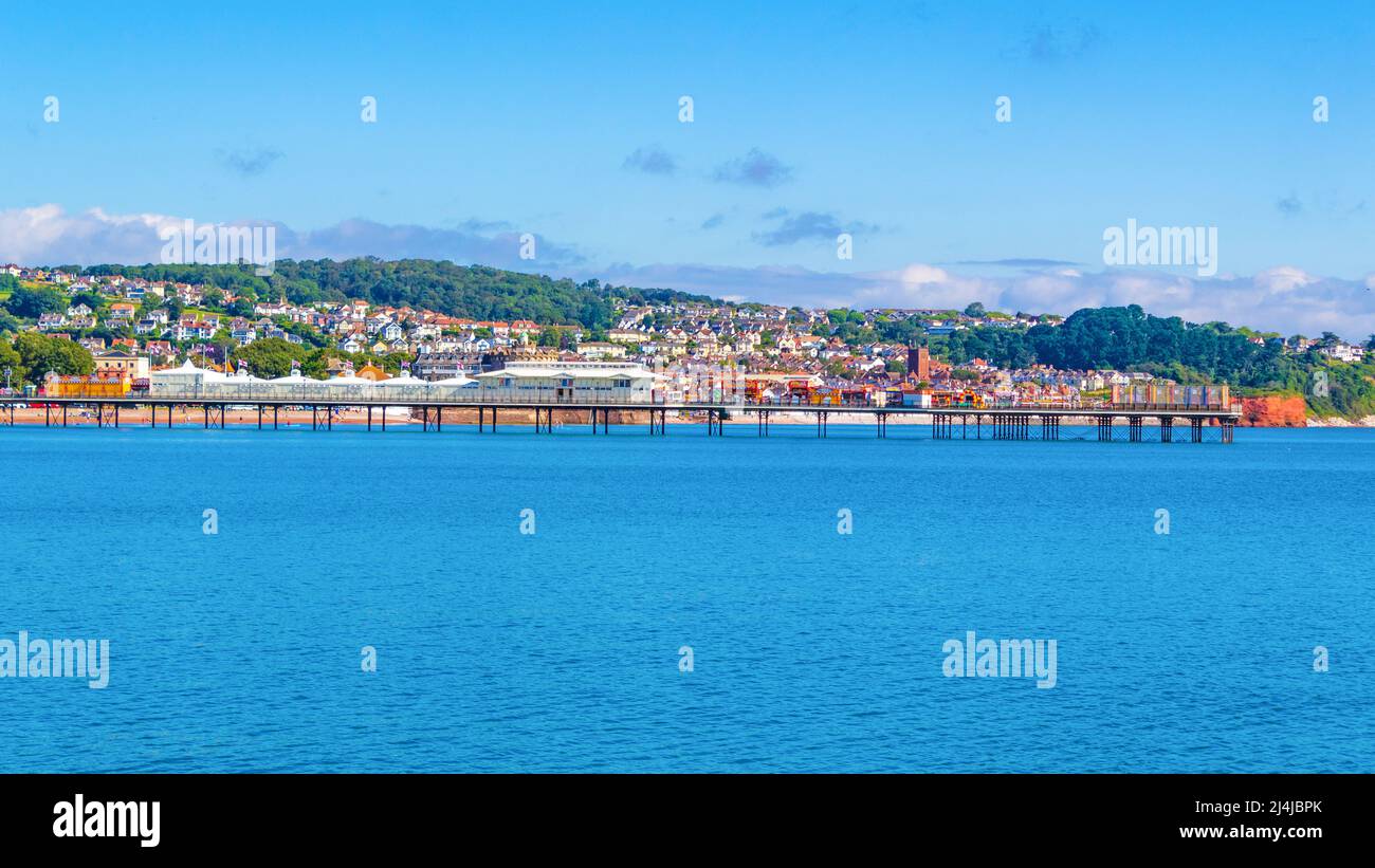 View of Paignton town seaside and beach with a long pier juts out from ...