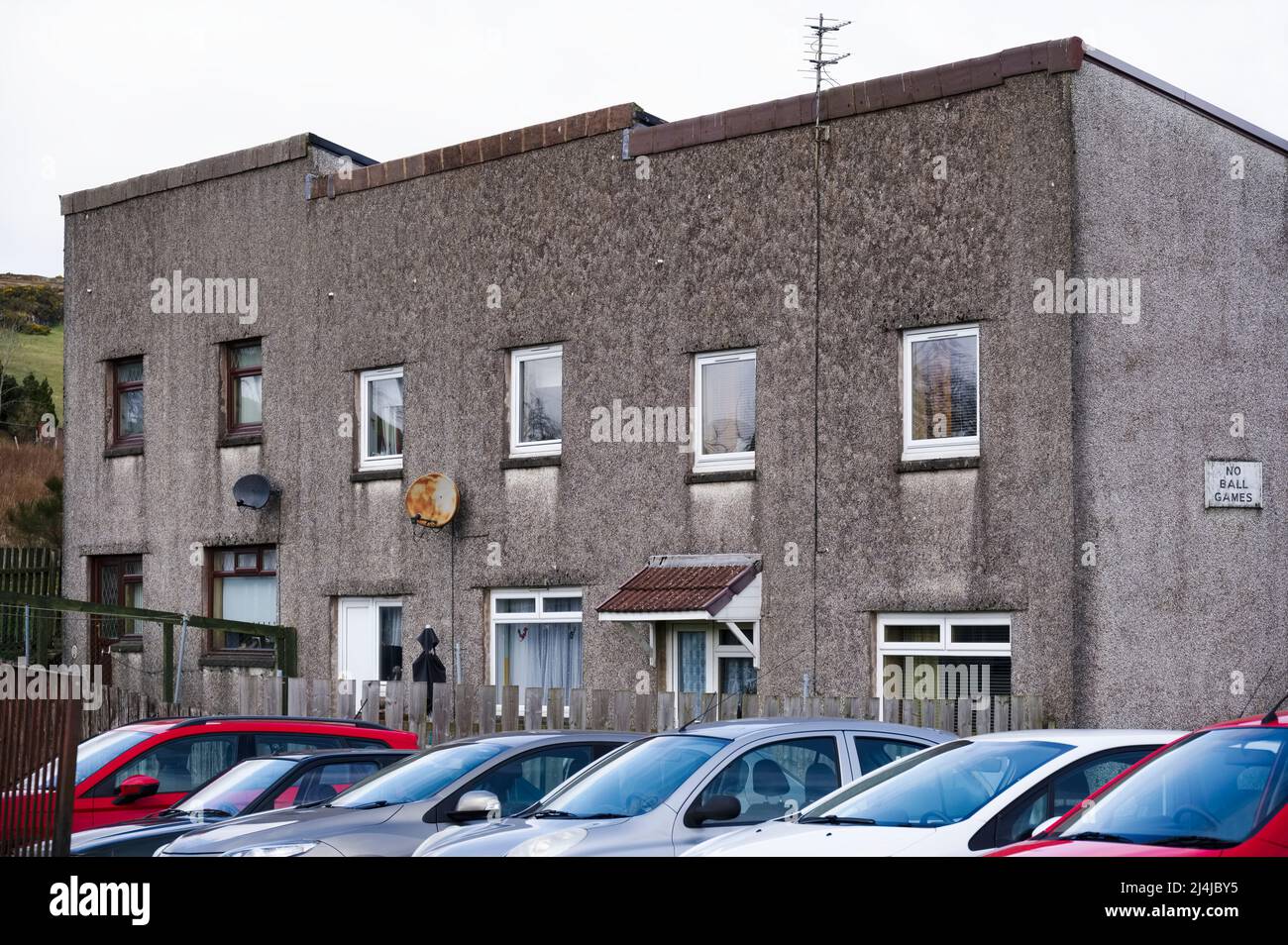 Derelict council house in poor housing estate slum with many social ...