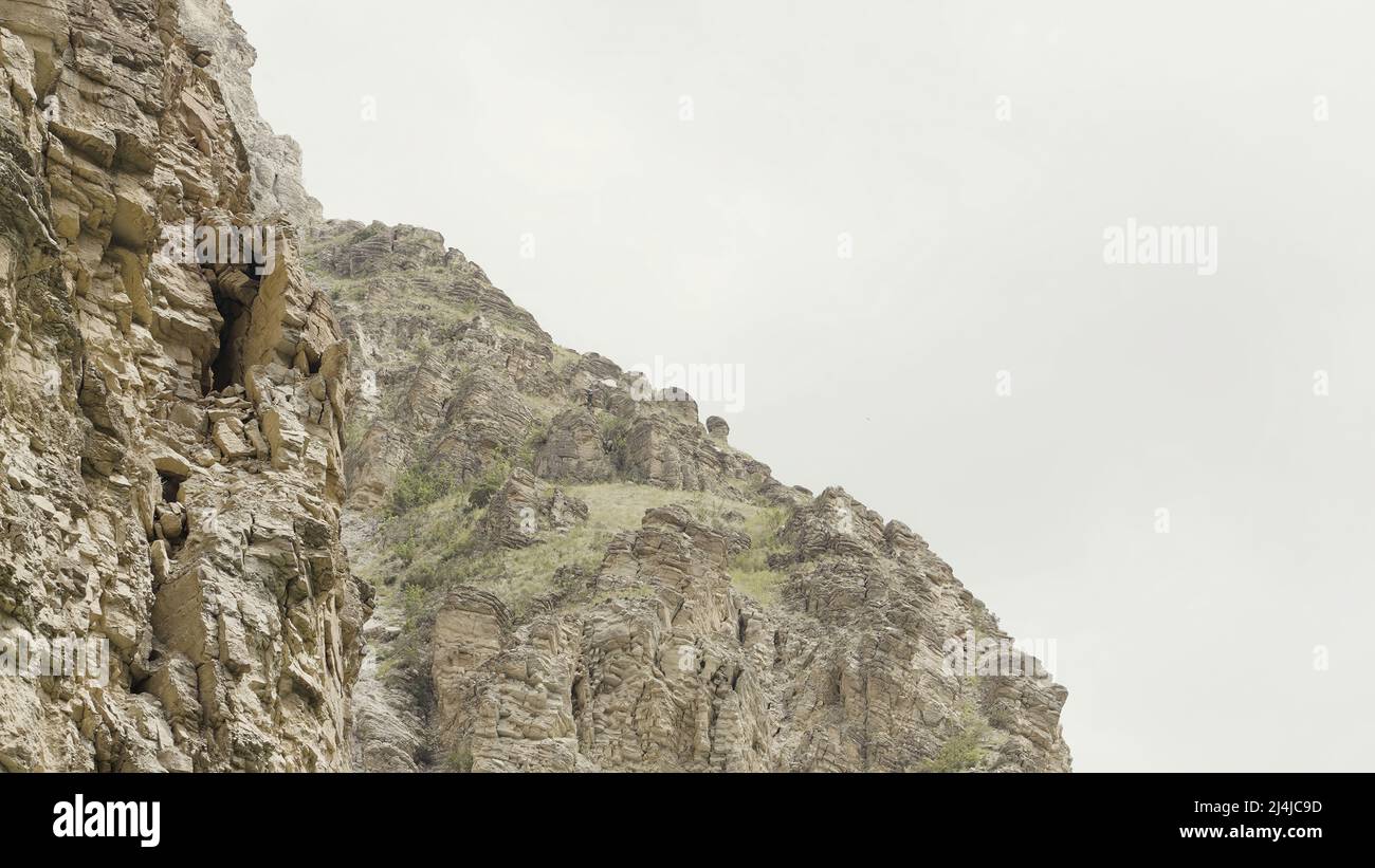 A beautiful high hill in the landscape . Action. A tall stone with a ...