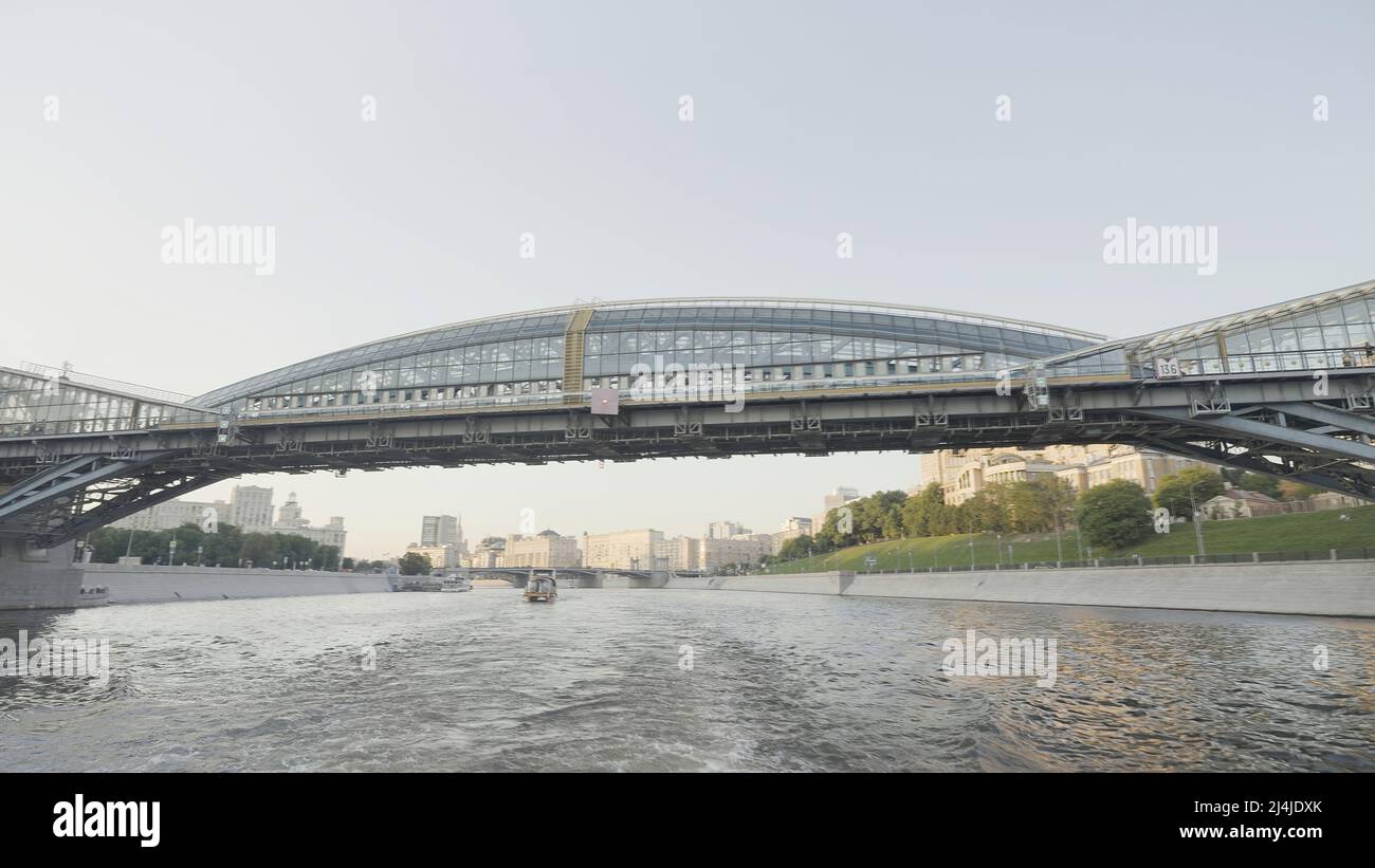 View from floating boat on city river with glass bridge. Action ...