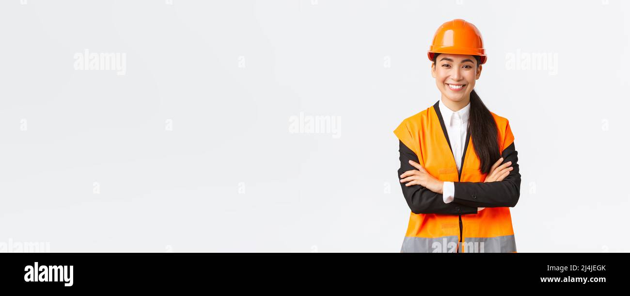 Smiling confident asian female chief manager at building, construction ...