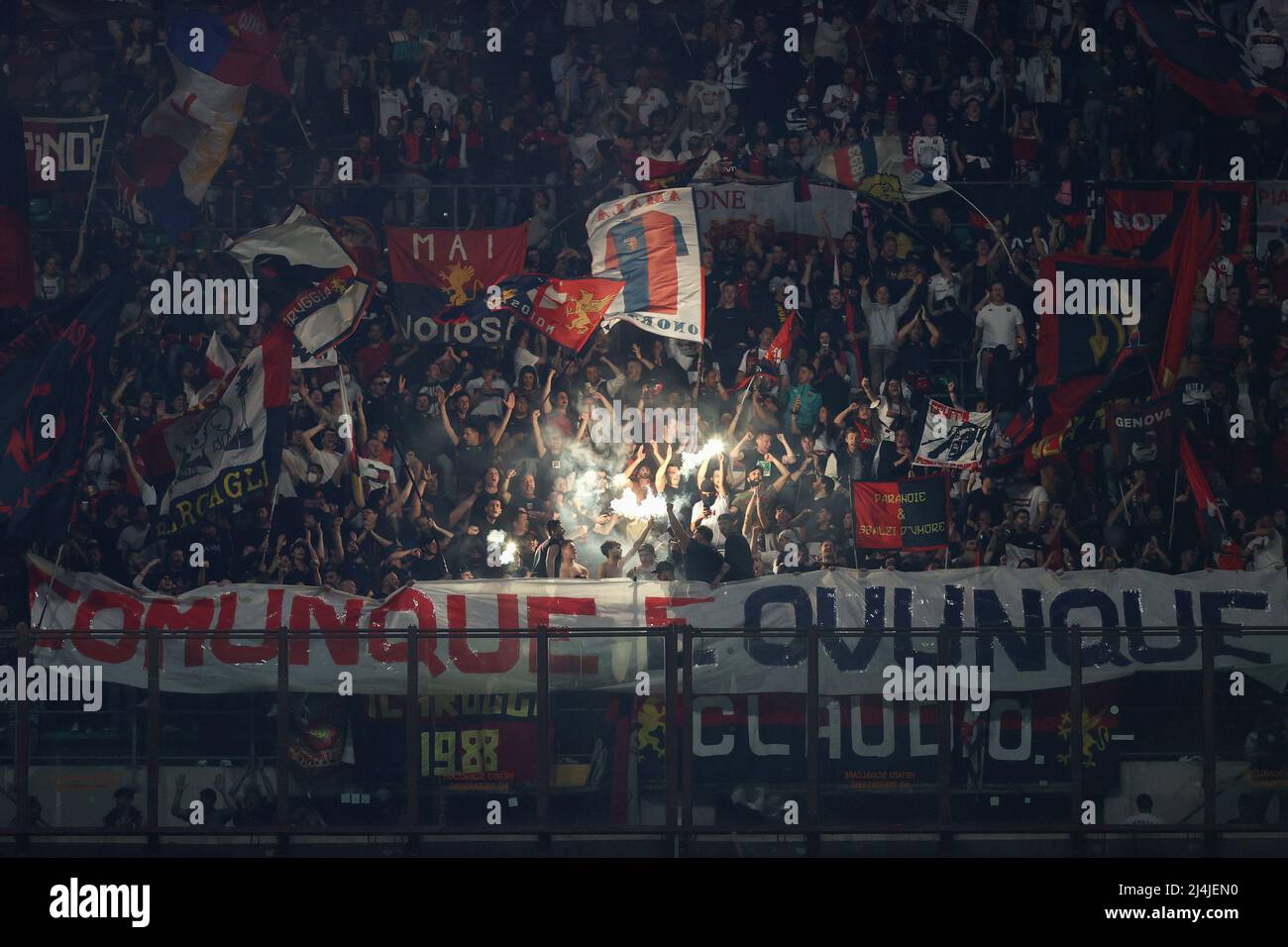 Genoa CFC fans light a torch and clap their hands during the italian ...