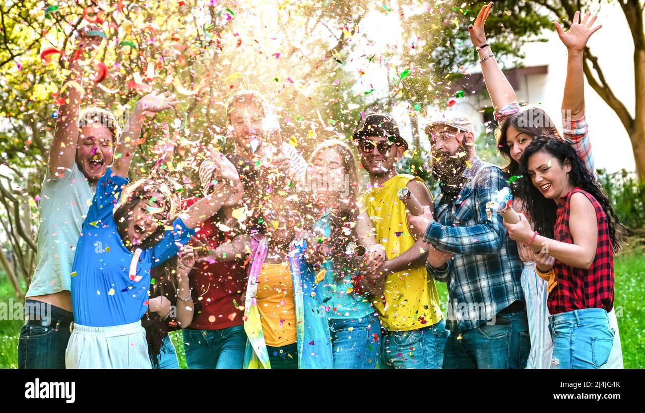 Happy excited friends having fun outdoor celebrating with confetti ...