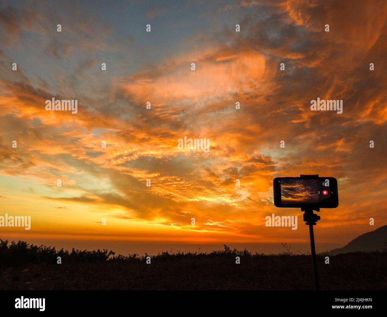 A phone capturing sunset at the golden hour fixed on a tripod Stock ...