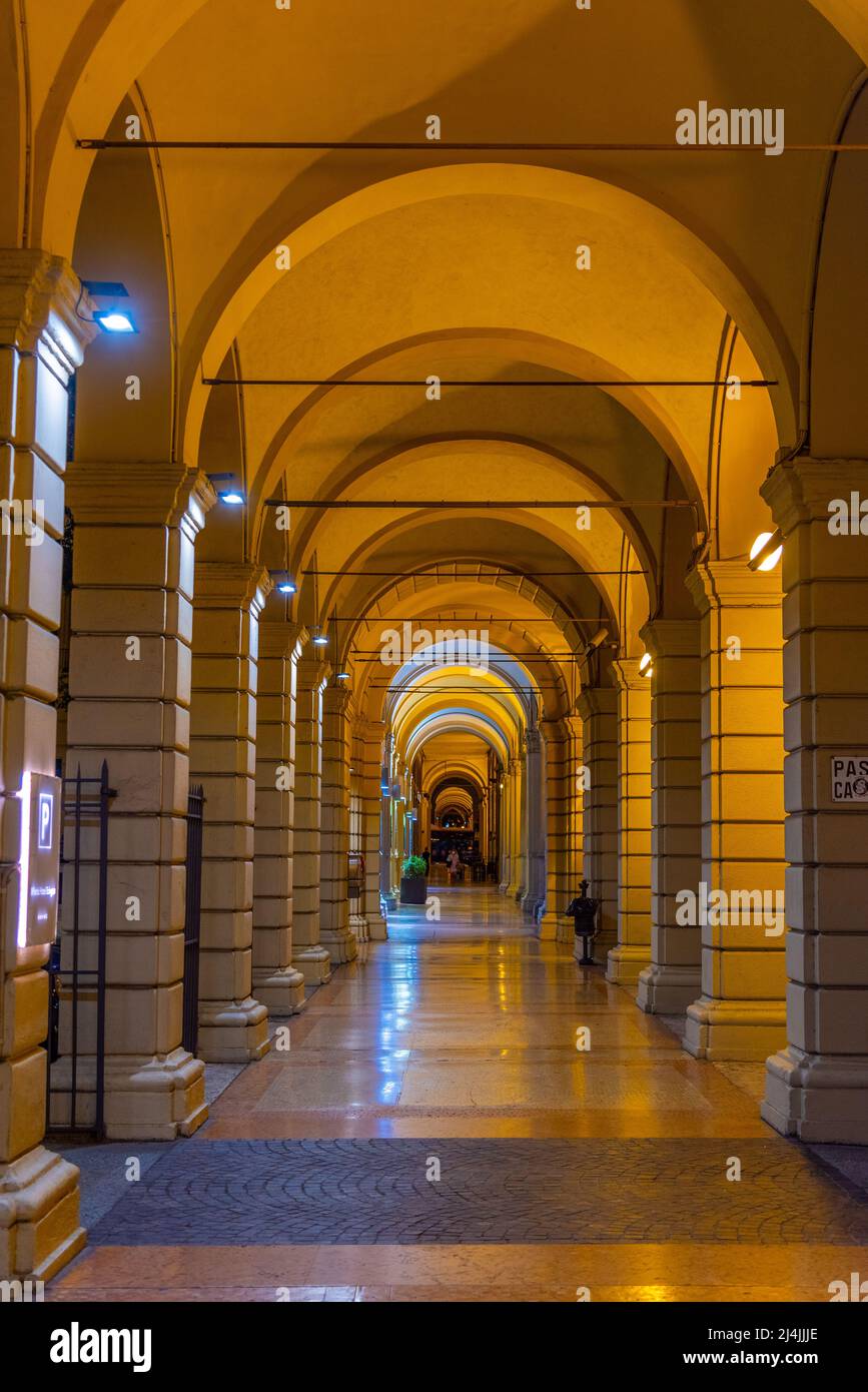 Night view of a covered arcade in the historical center of the italian ...