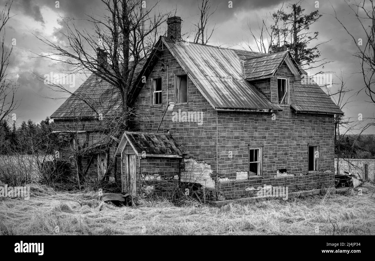 An old black and white abandoned haunted spooky looking farmhouse in ...