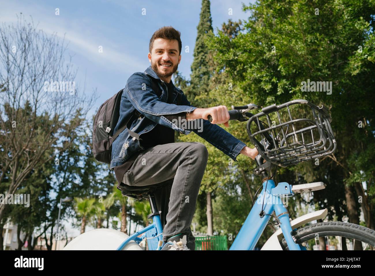Cycling trip, handsome college student with a backpack prefers a ...