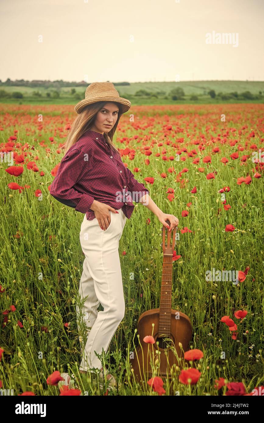 spring countryside. lady wear checkered shirt and hat in flower field ...