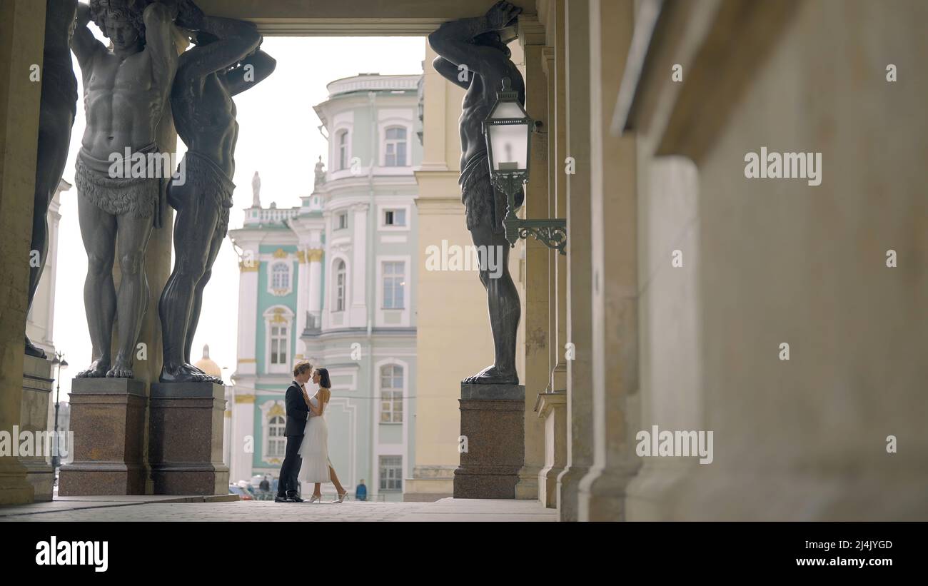 Beautiful newlyweds hug at old building. Action. Small silhouette of ...