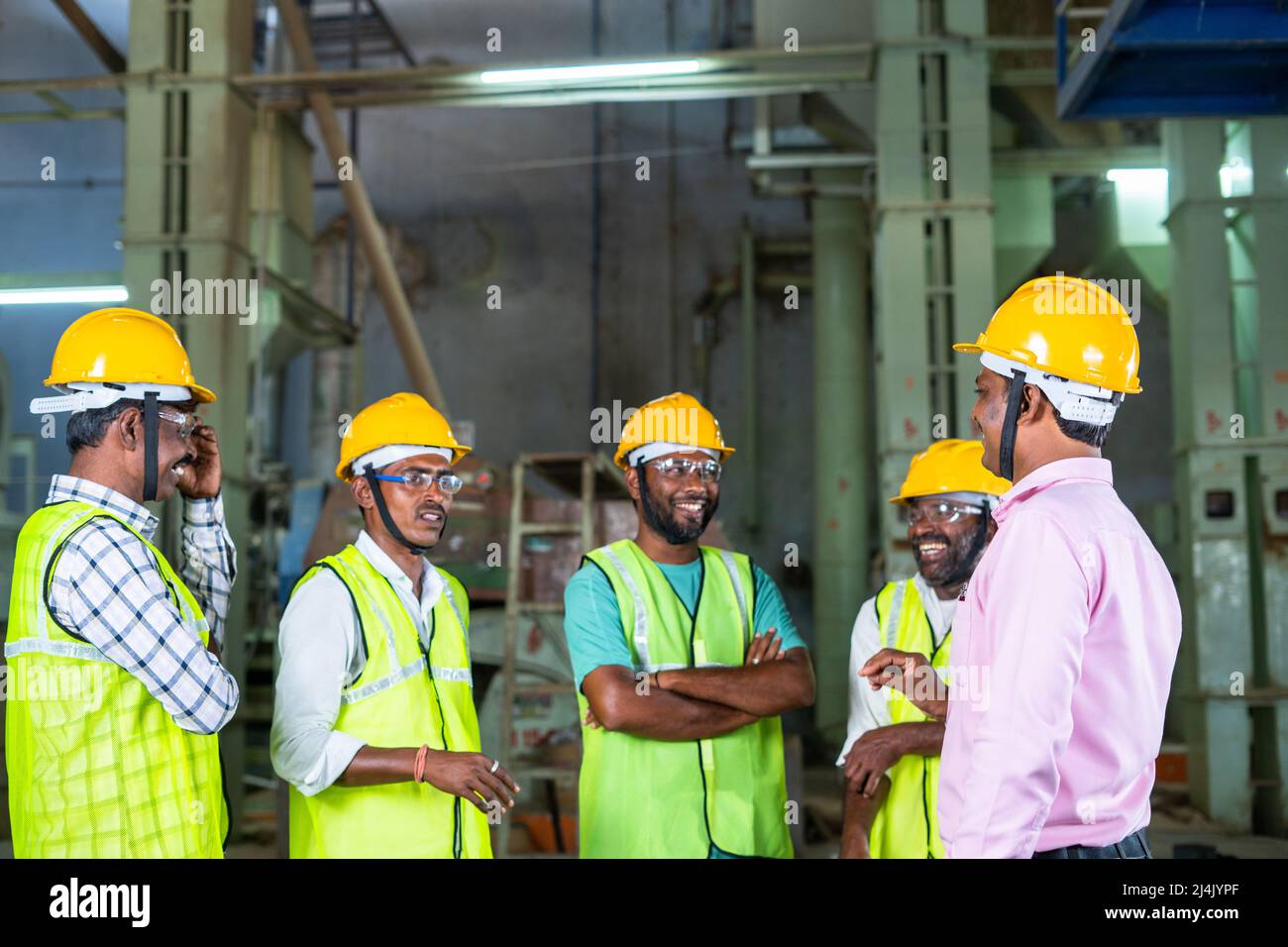 focus on manager, group of industrial workers having fun chat with ...