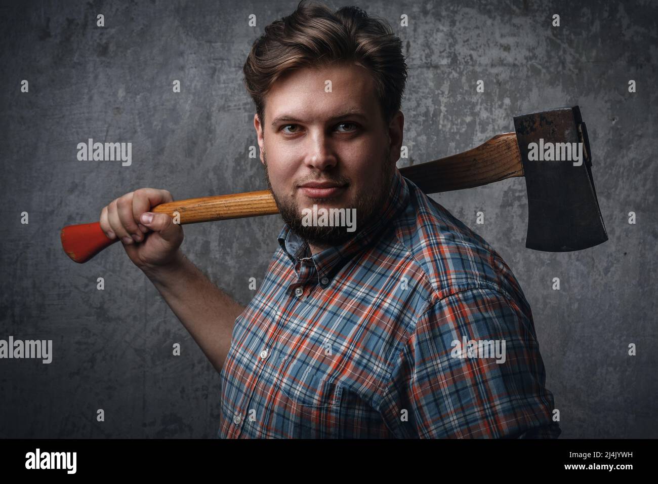 Portrait of bearded man with axe posing in studio Stock Photo - Alamy