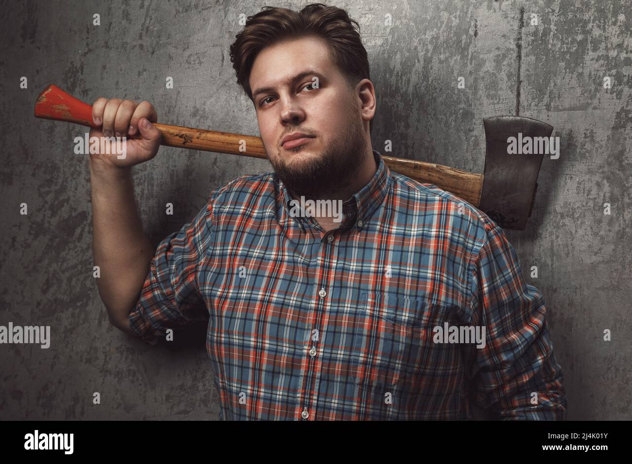 Portrait of bearded man with axe posing in studio Stock Photo - Alamy