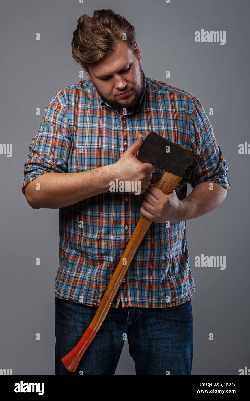 Portrait of bearded man with axe posing in studio Stock Photo - Alamy