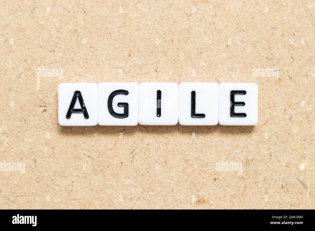 White tile alphabet letter with word agile on wood background Stock ...