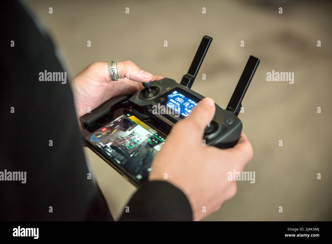 Man hands holding transmitter with attached mobile phone device and ...